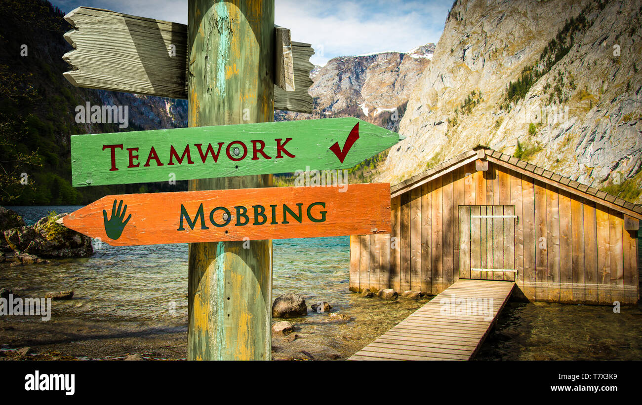 Street Sign the Direction Way to Teamwork versus Mobbing Stock Photo ...