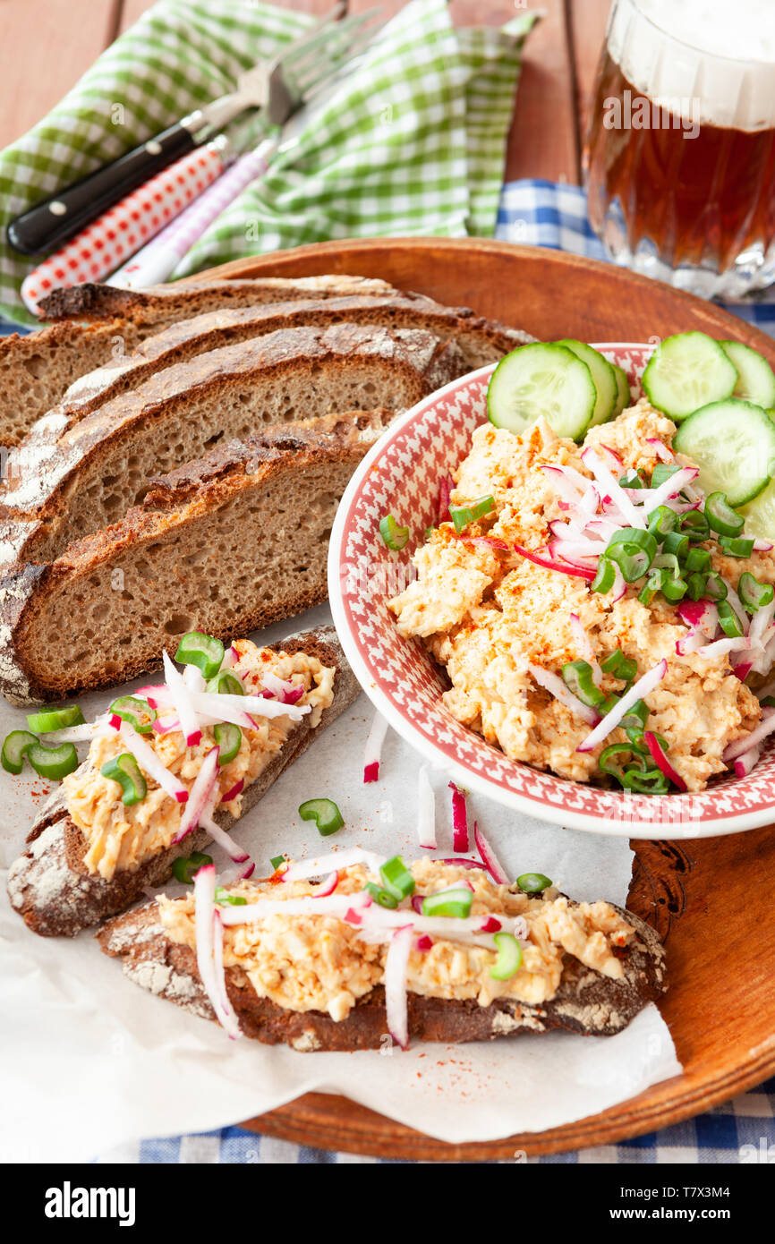 Traditional bavarian cheese dish with fresh sliced rye bread Stock ...