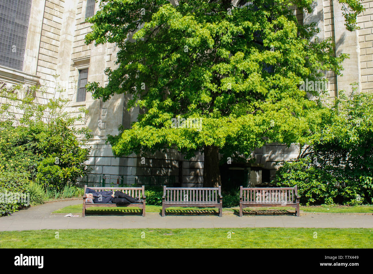 Man napping on bench Stock Photo - Alamy