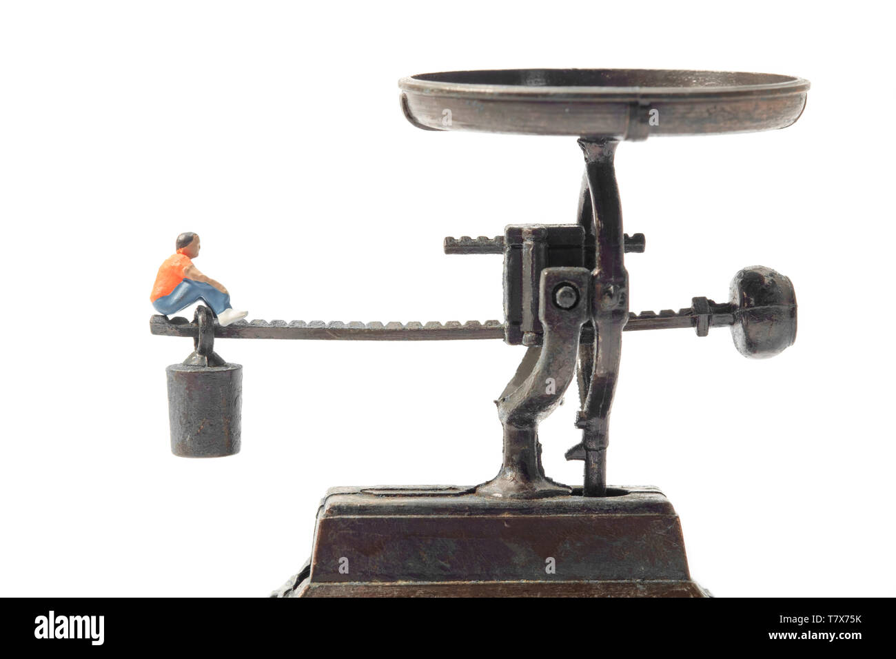 View of miniature toy people sit on scales Stock Photo - Alamy