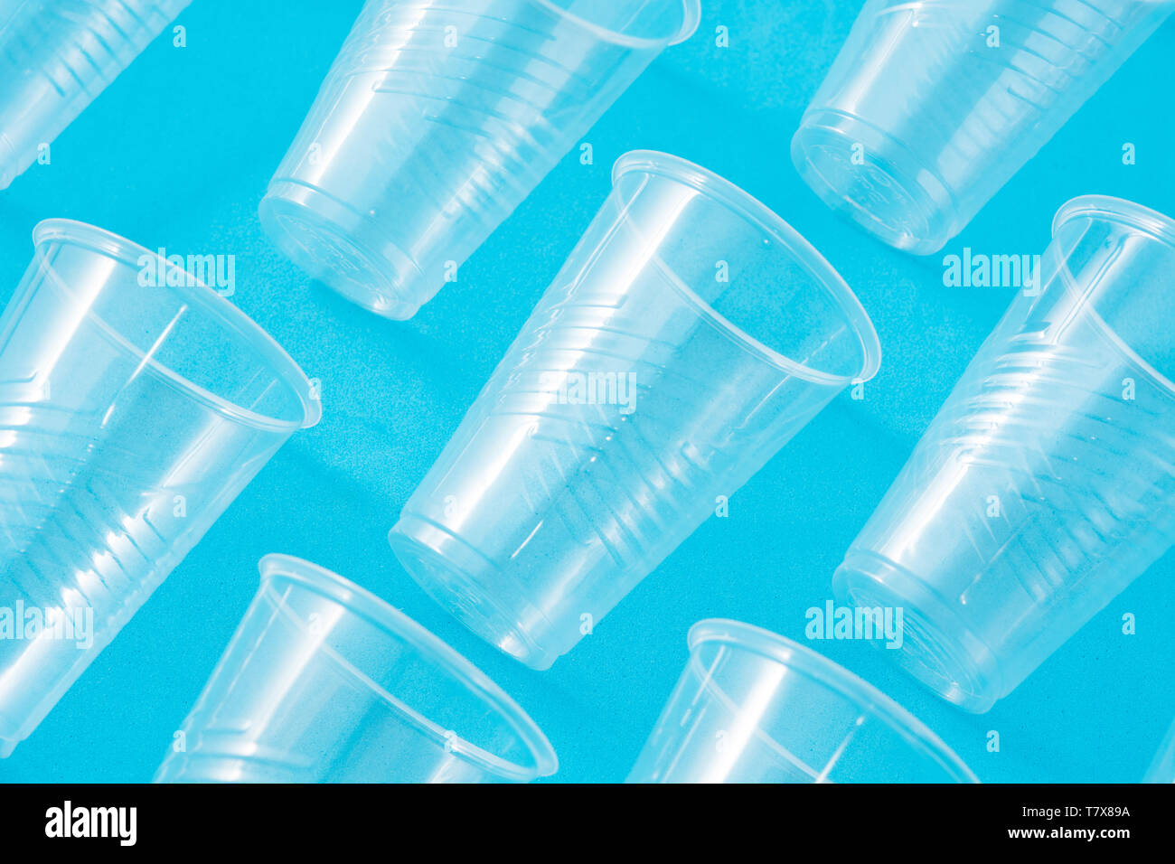 Disposable waste plastic cups pattern on blue background Stock Photo ...