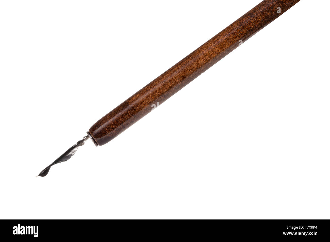 side view of black ink drop in nib of brown dip pen close up isolated ...