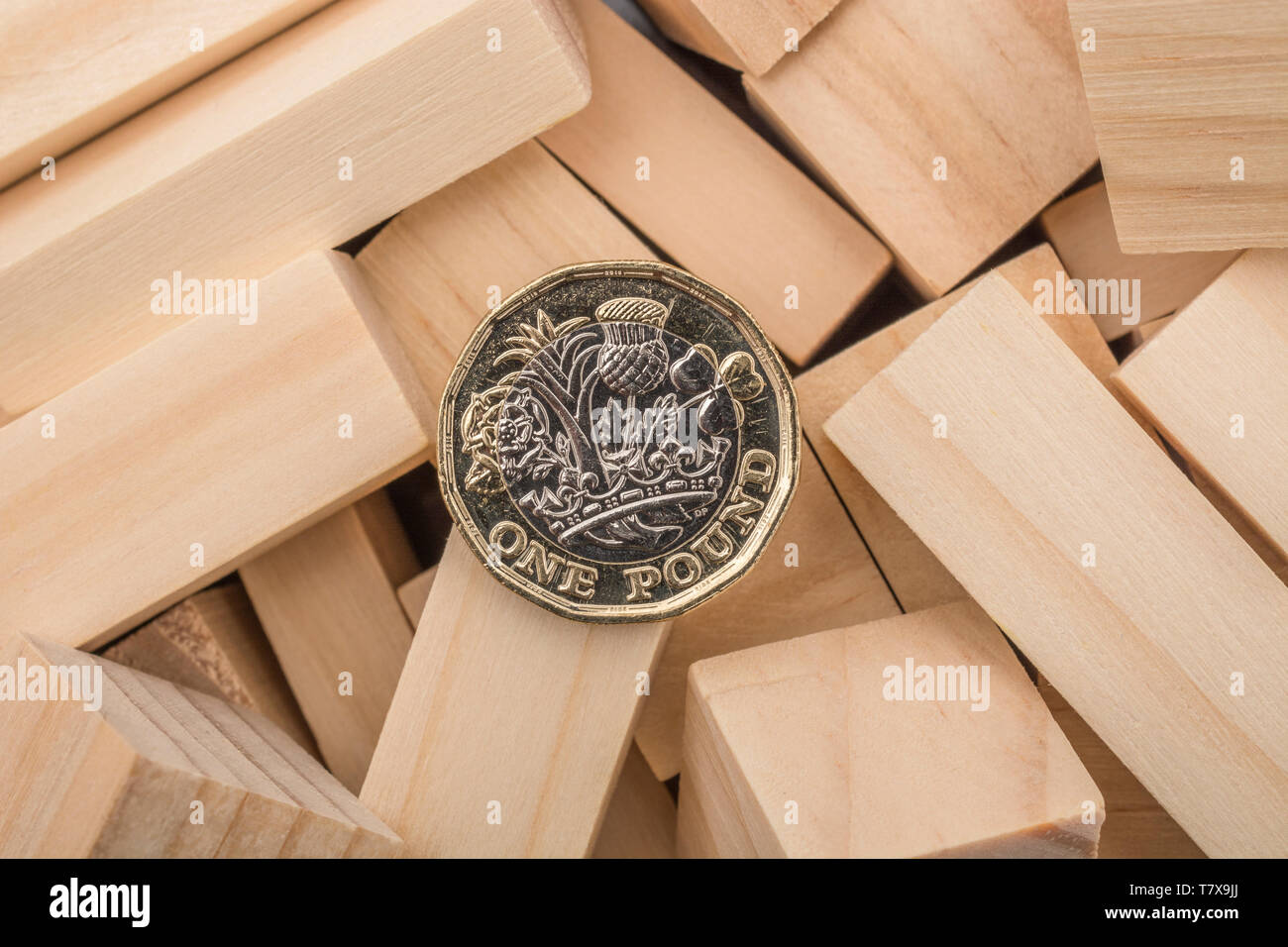 New pound coins + jumbled / tumbled wooden bricks & blocks. Sterling ...