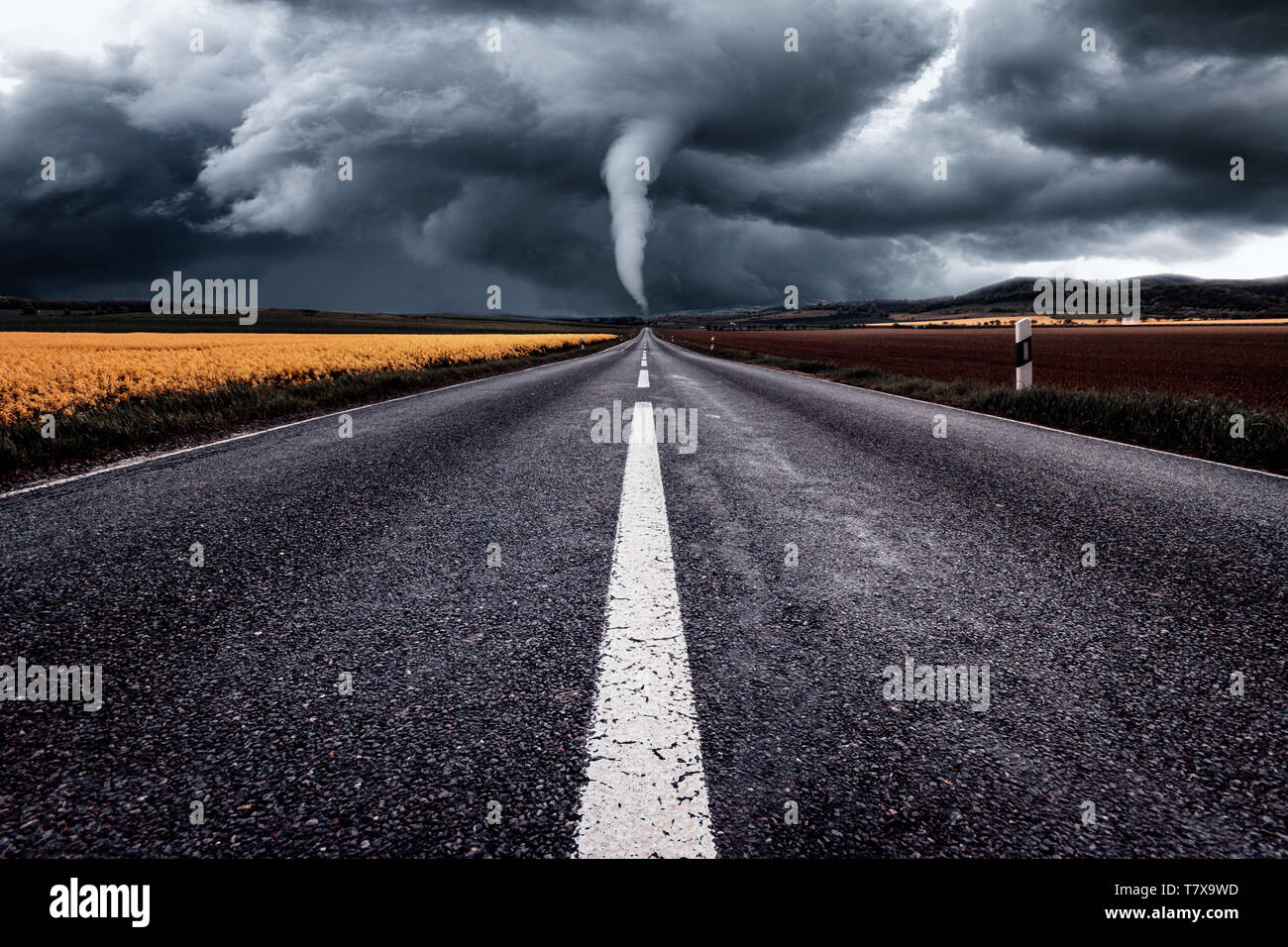 Road ends up leading to a tornado storm Stock Photo - Alamy
