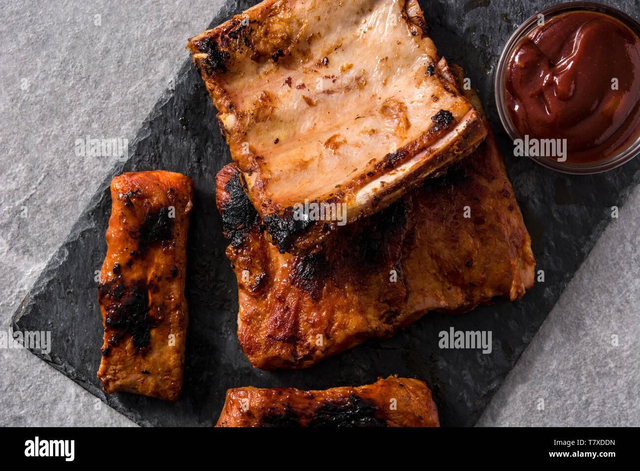 Grilled barbecue ribs on grey stone background Stock Photo - Alamy