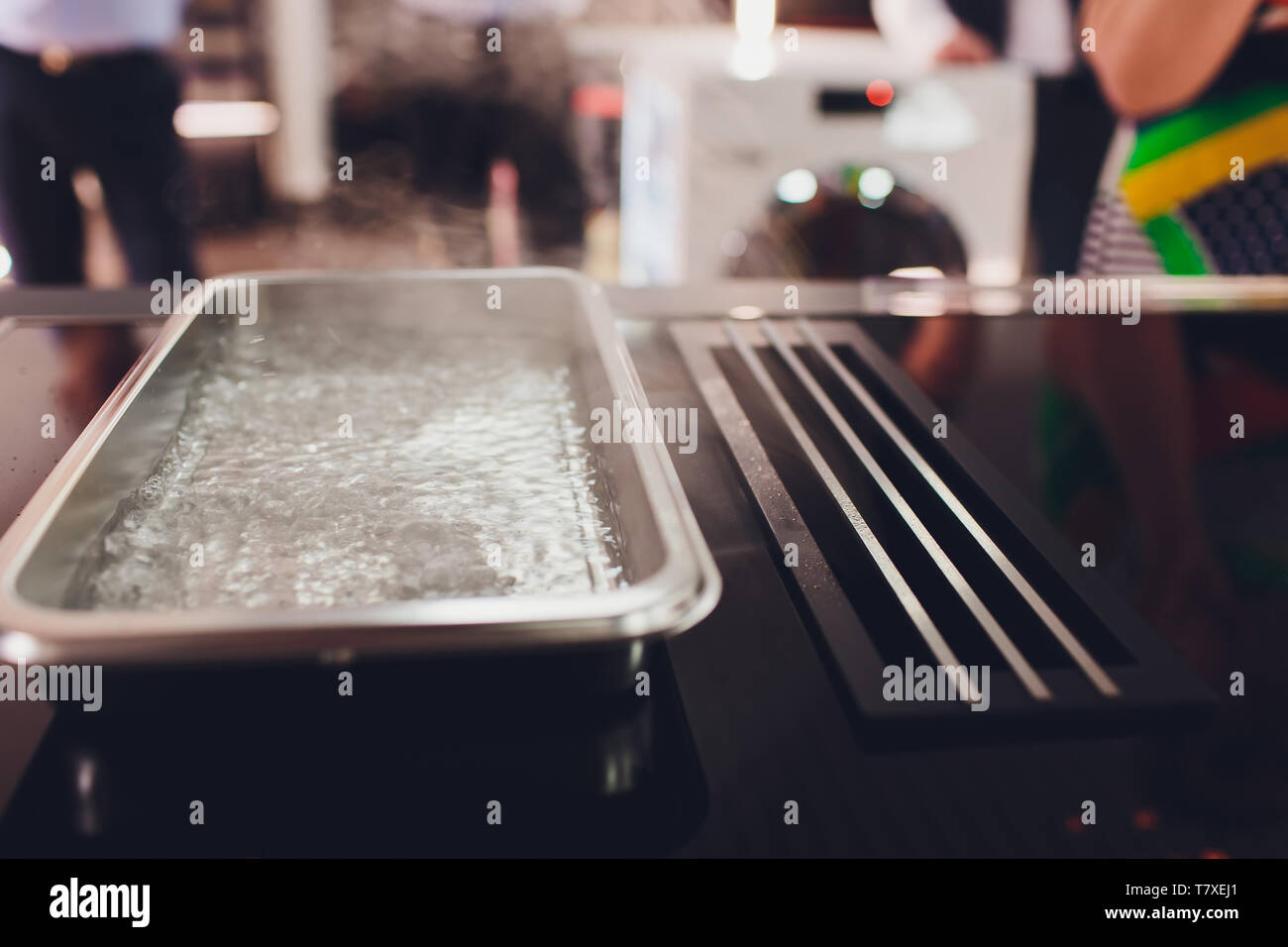 Closeup of exhaust hood and ceramic cooking plate in the new modern ...