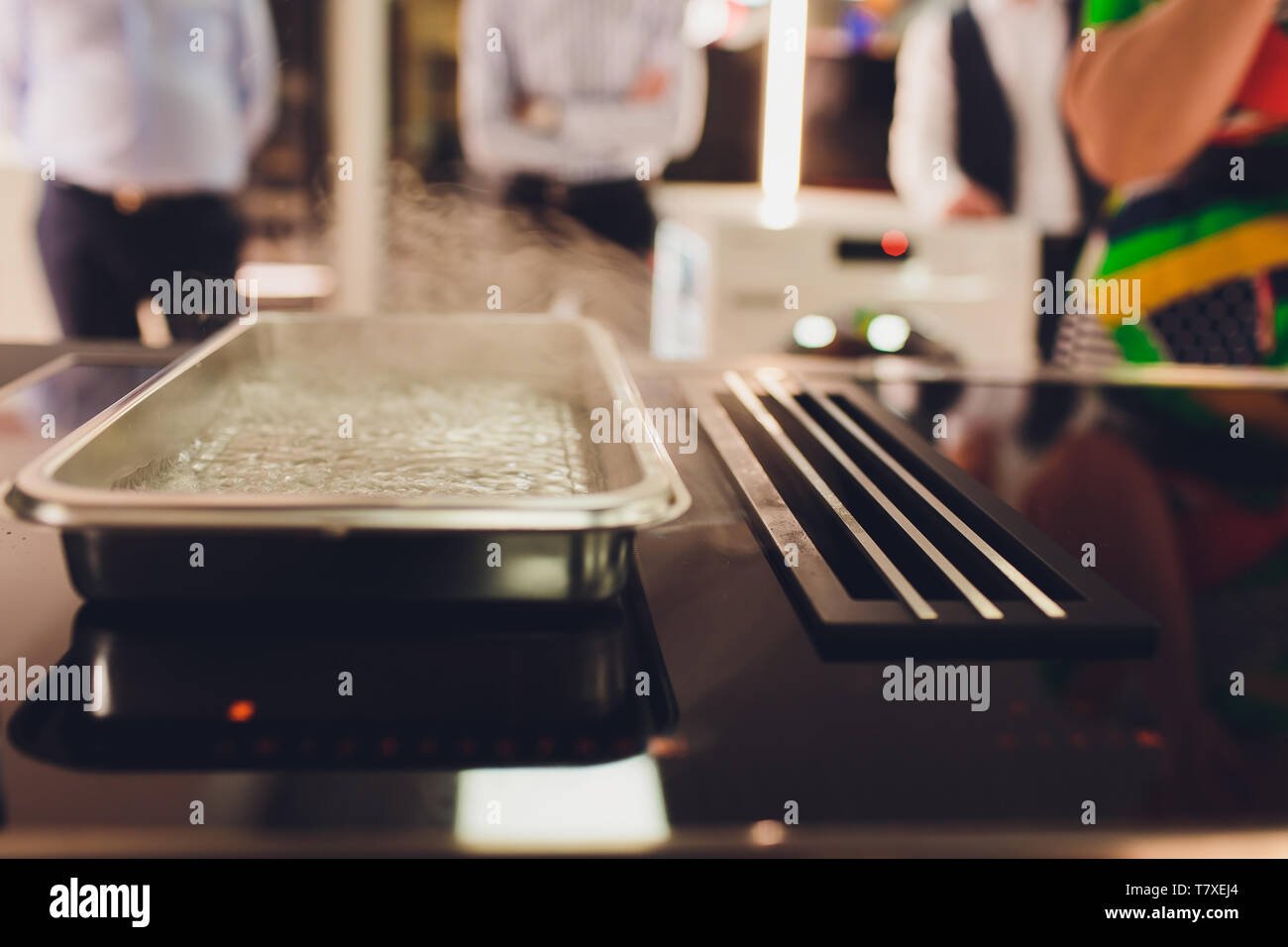 Closeup of exhaust hood and ceramic cooking plate in the new modern ...