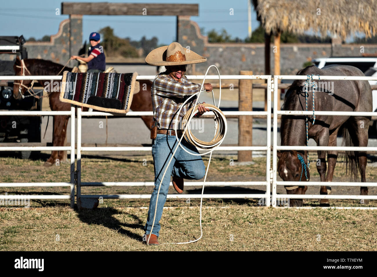 A Charro practices roping tricks during a family charro practice ...