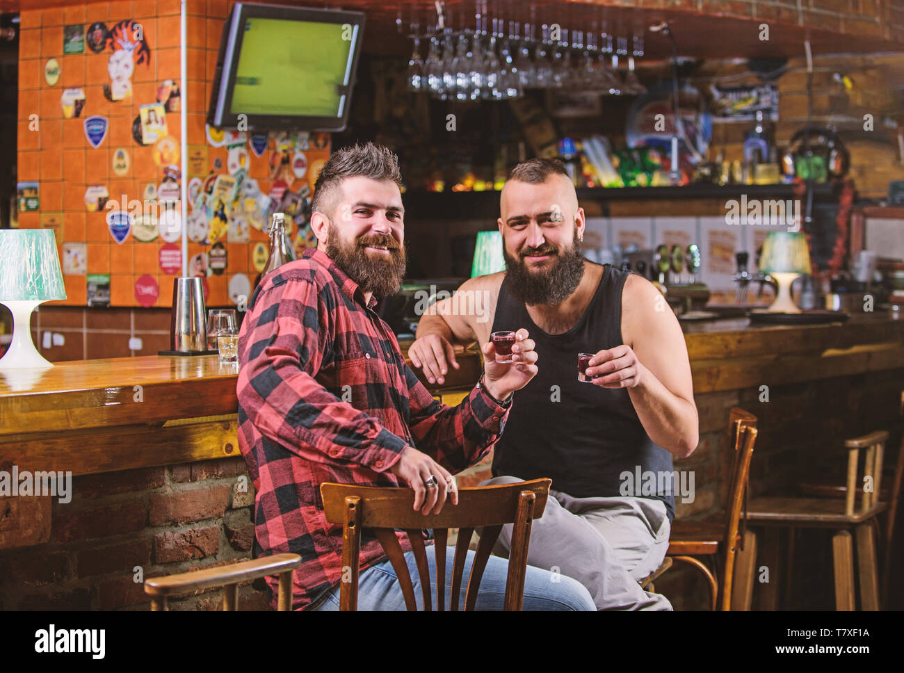 Friday relax in pub. Friends relaxing in pub. Cheers concept. Hipster ...