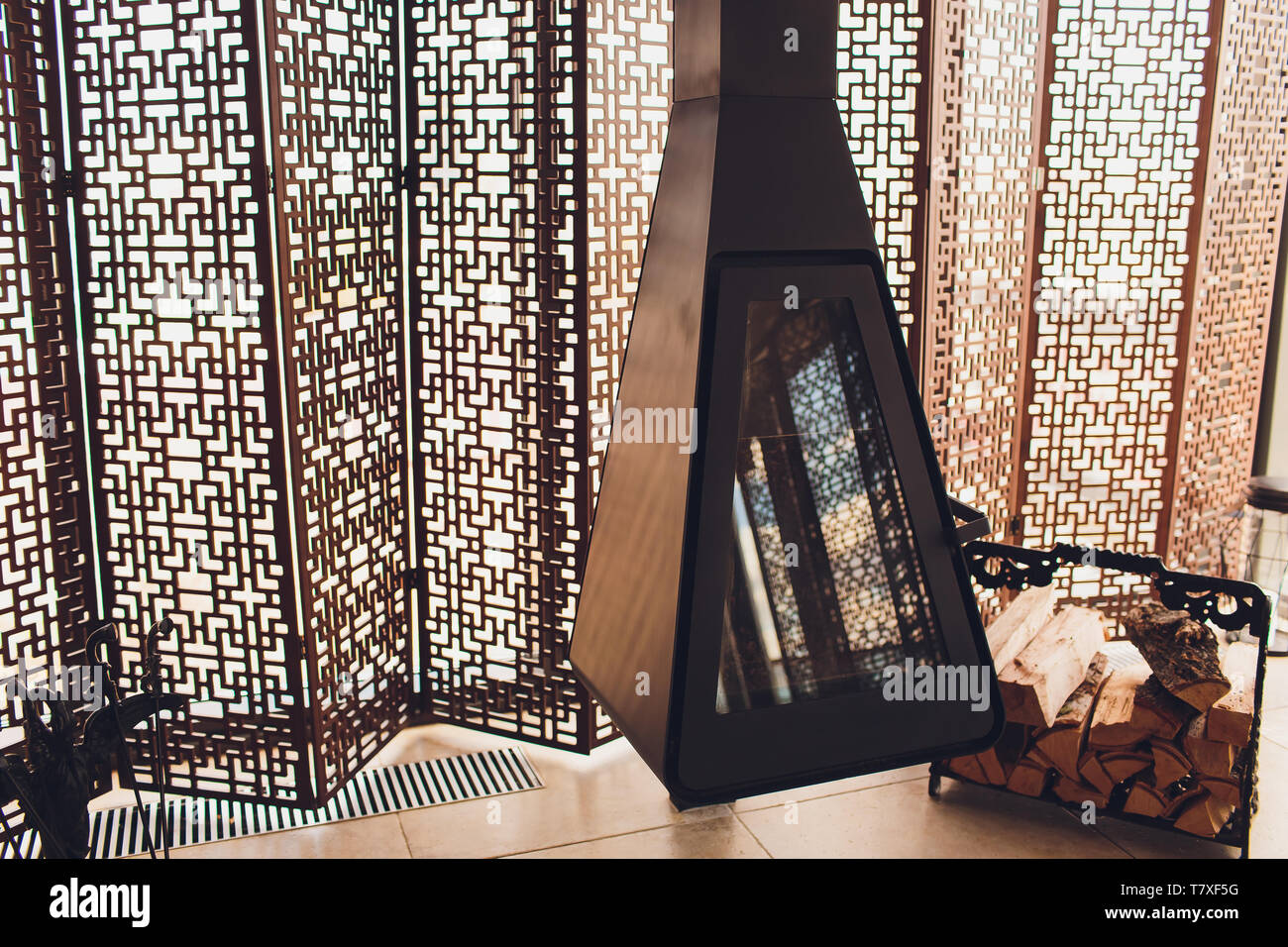 Stylish modern room with a burning fireplace, modern hinged fireplace ...