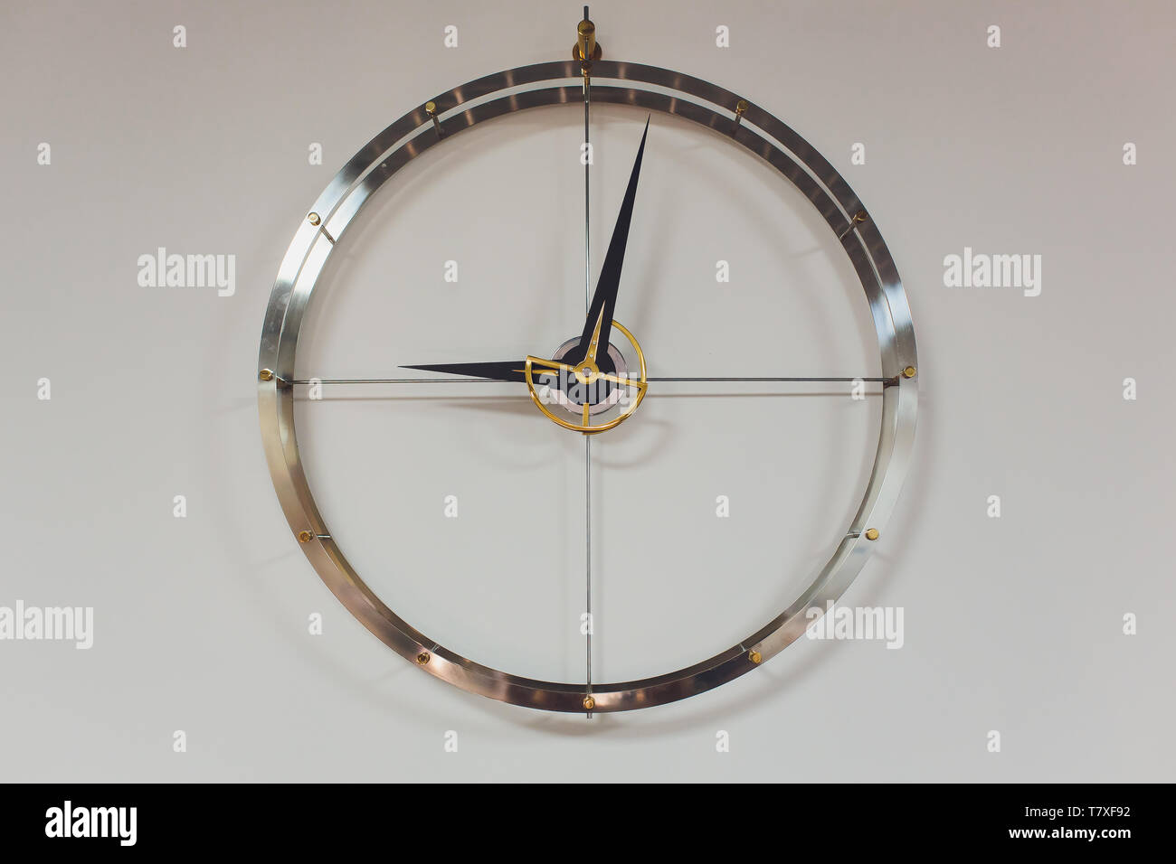 Metal clock on the wall of steel Stock Photo - Alamy