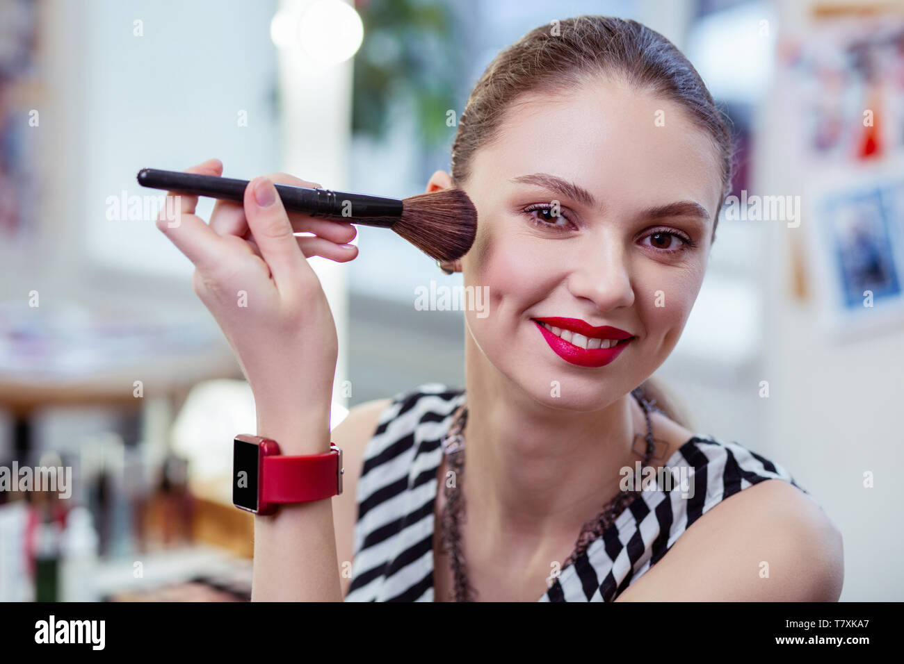 Woman with makeup brush hi-res stock photography and images - Alamy