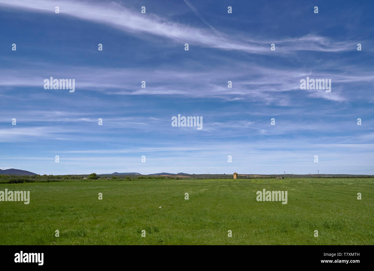 A Spanish Farm Tower stands in an arable Field next to the Lagoon of ...