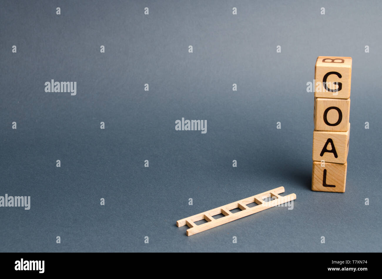 A tower of cubes with an inscription goal and a fallen ladder. Tool for ...