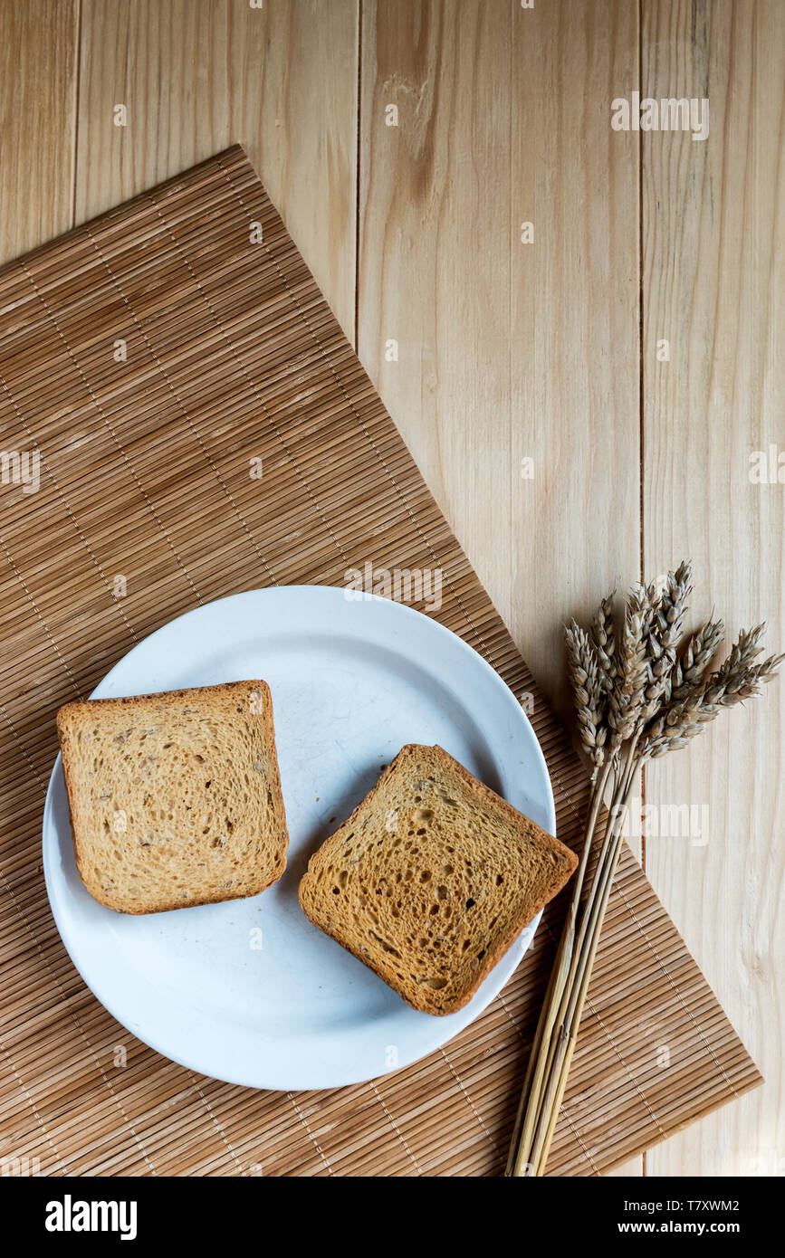 Two Slices of Toast Bread and Ear of Wheat on a Wooden Table Setup ...