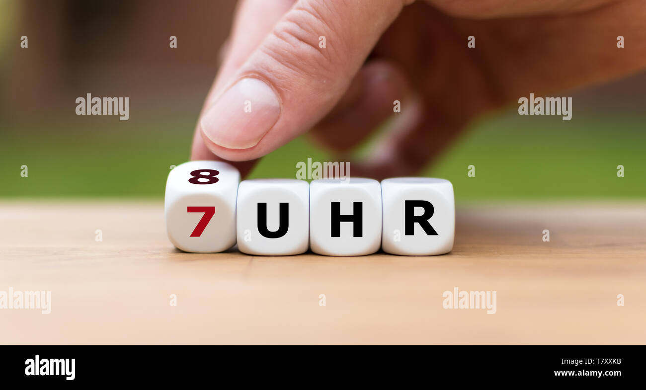 Concept for getting up early in the morning. Hand turns a dice and ...