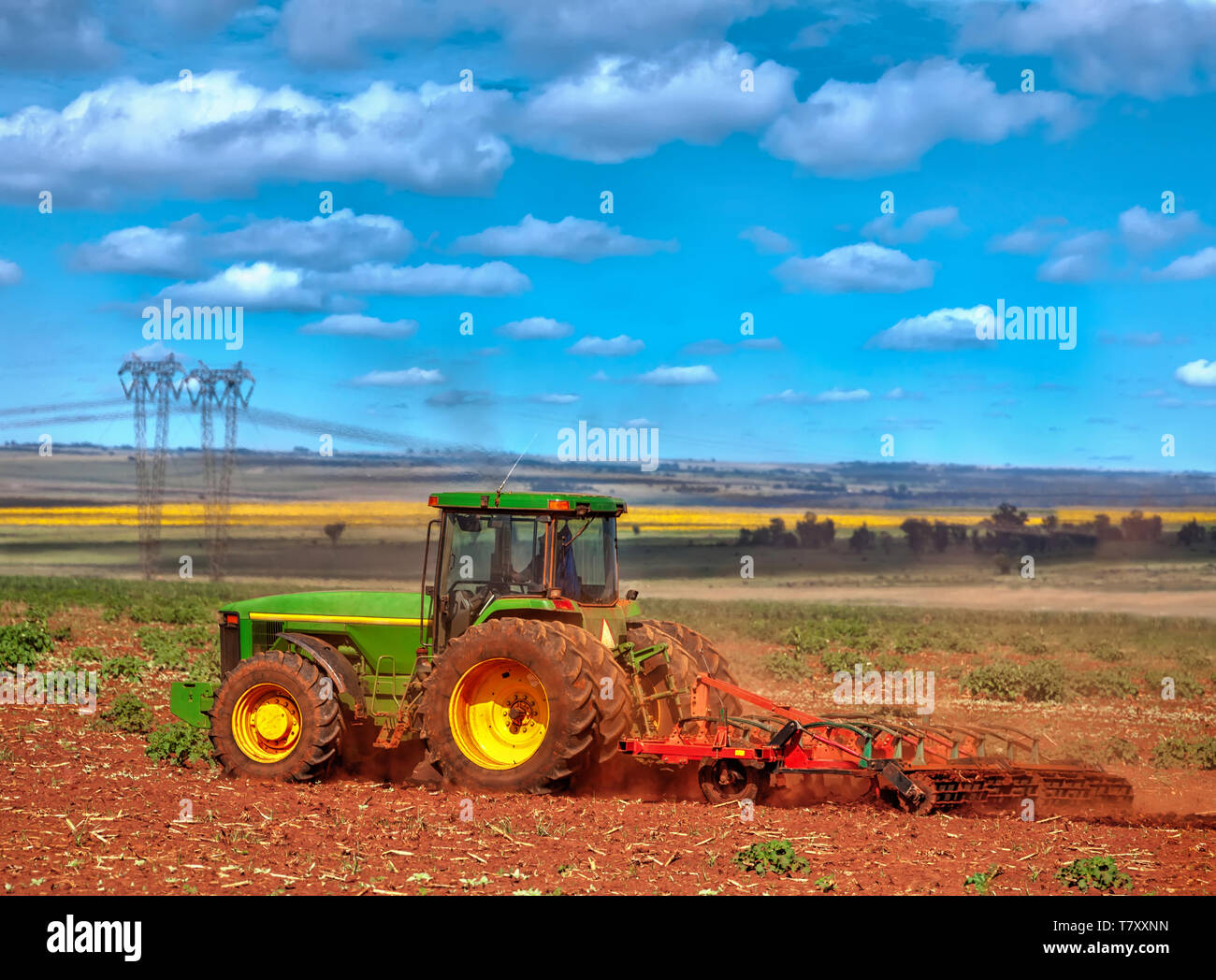 green tractor plugging the field Stock Photo - Alamy