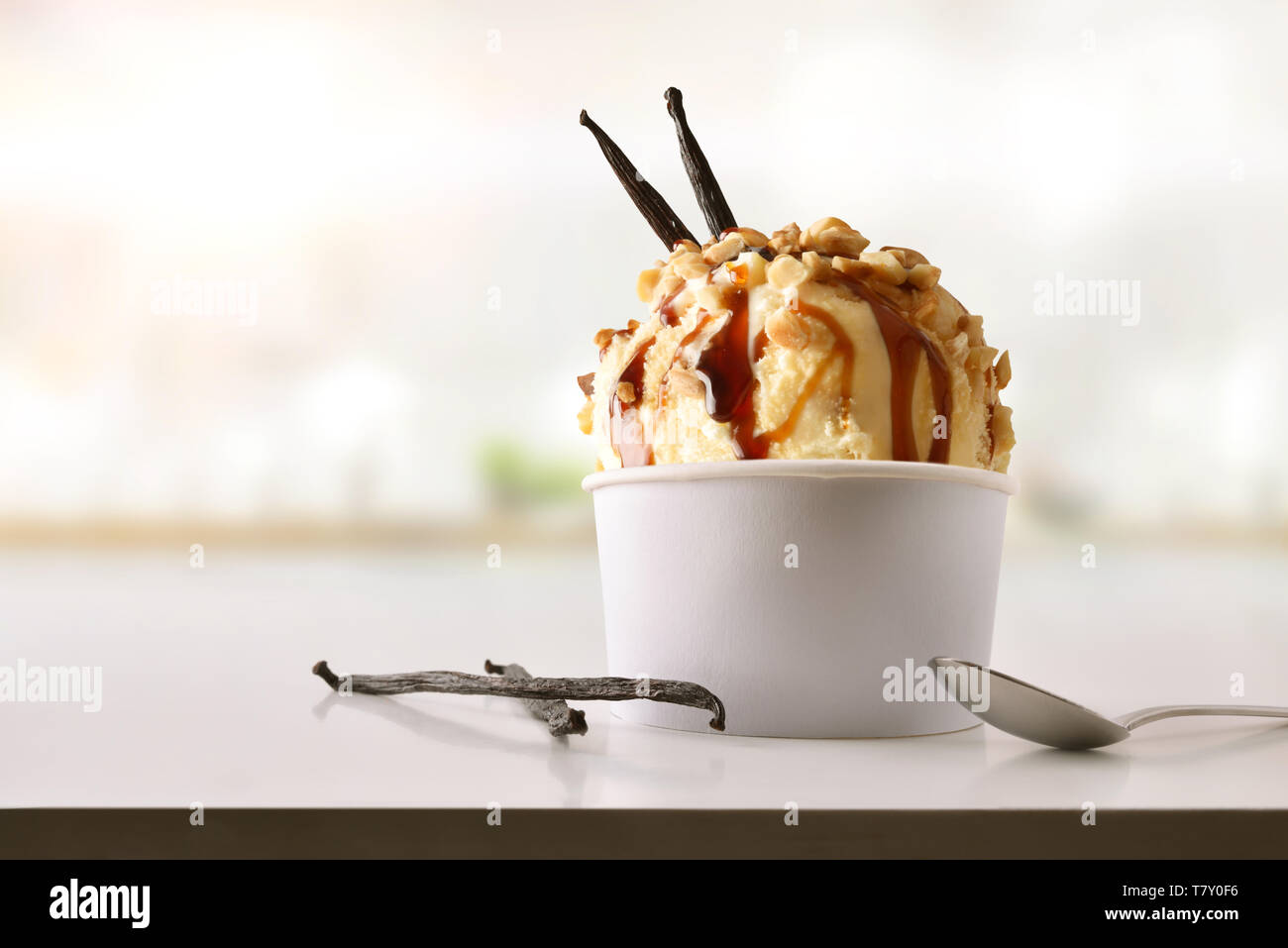 Vanilla ice cream cup on white table homemade with kitchen background ...