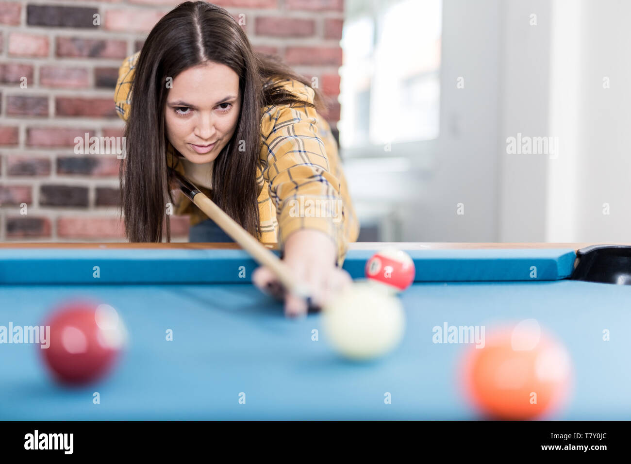 Portrait of young female playing billiards Stock Photo - Alamy