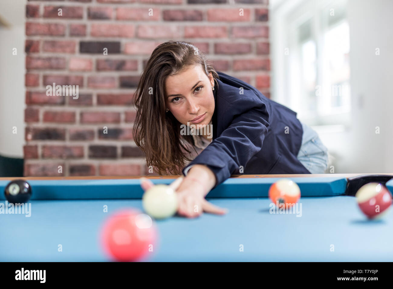 Fashionable modern woman playing pool table billiards game Stock Photo ...