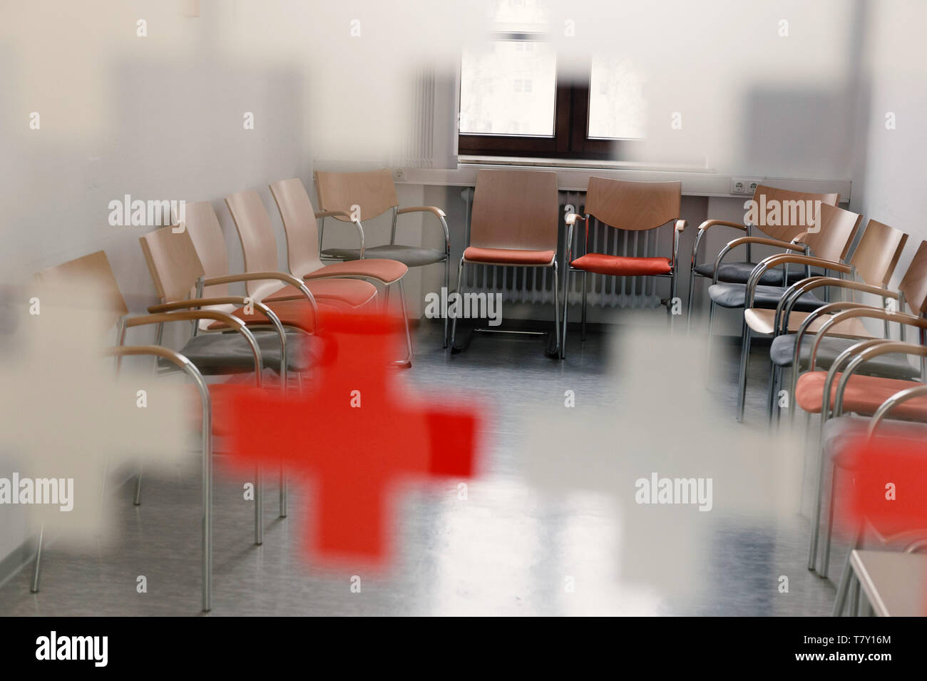 Look through a glass window in an empty waiting room in a hospital ...