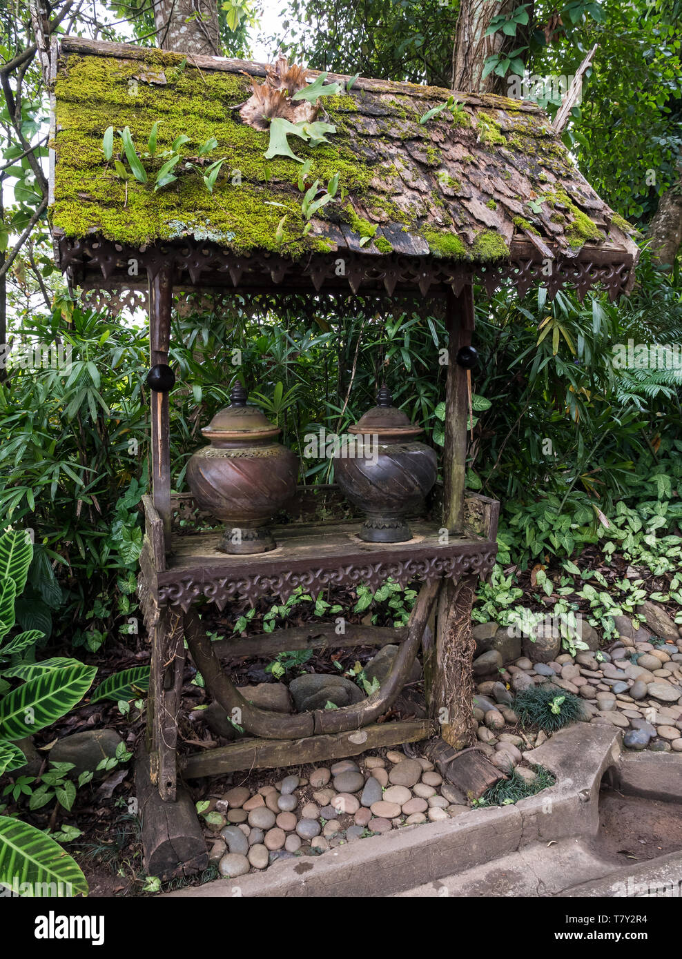 Old clay pot for drinking water in the wooden pavilion of the garden ...