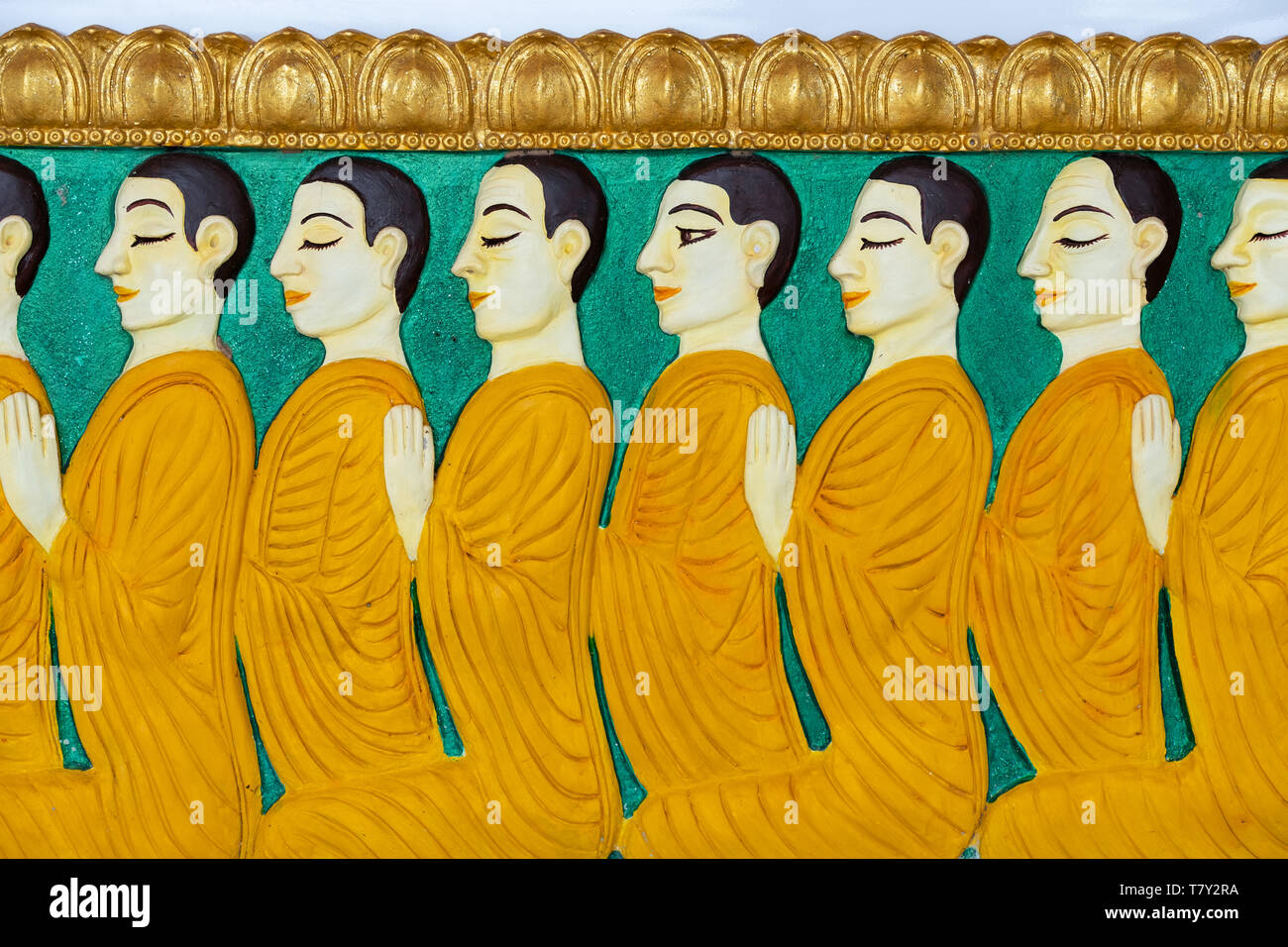 Monk pattern on the stucco wall of the Thai church.(Public area not ...