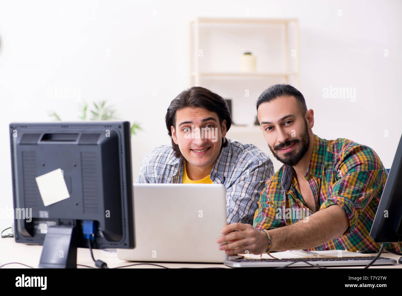 Two it specialists working in the office Stock Photo - Alamy
