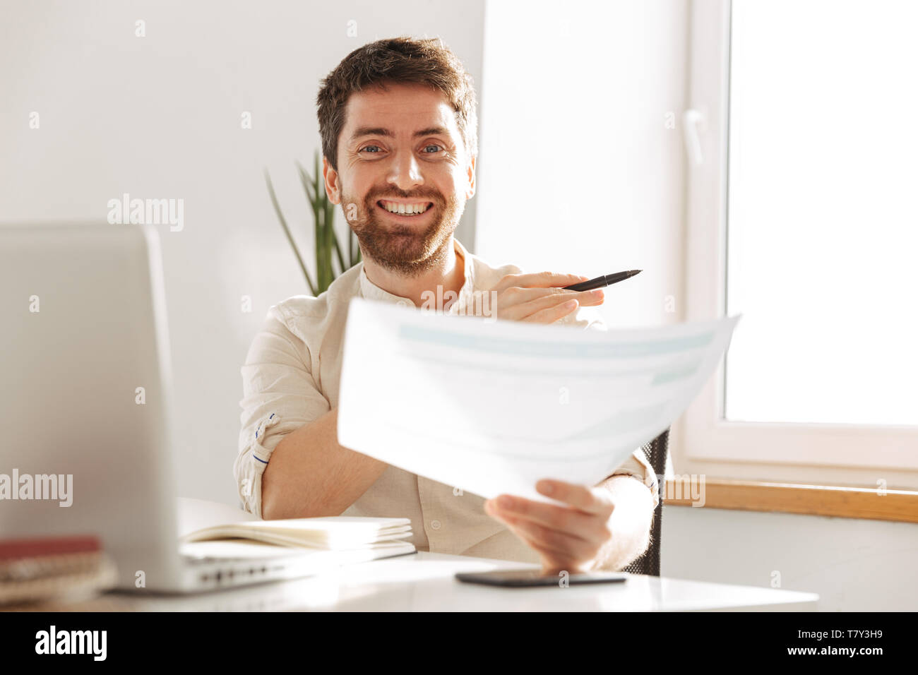 Image of attractive office guy 30s wearing white shirt using laptop and ...