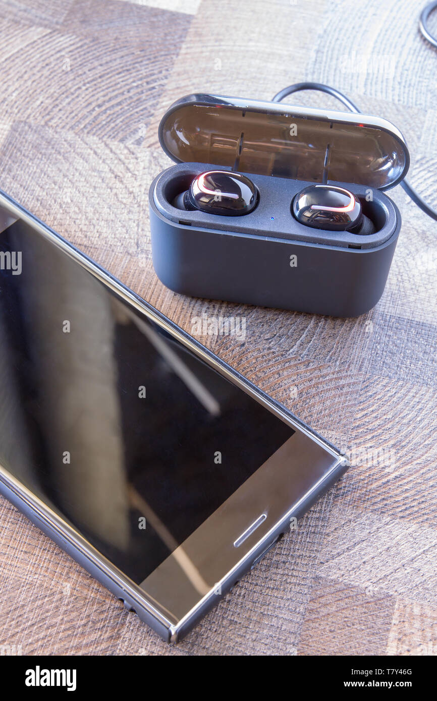 Smartphone Earphones with Bluetooth connection in black color Stock ...