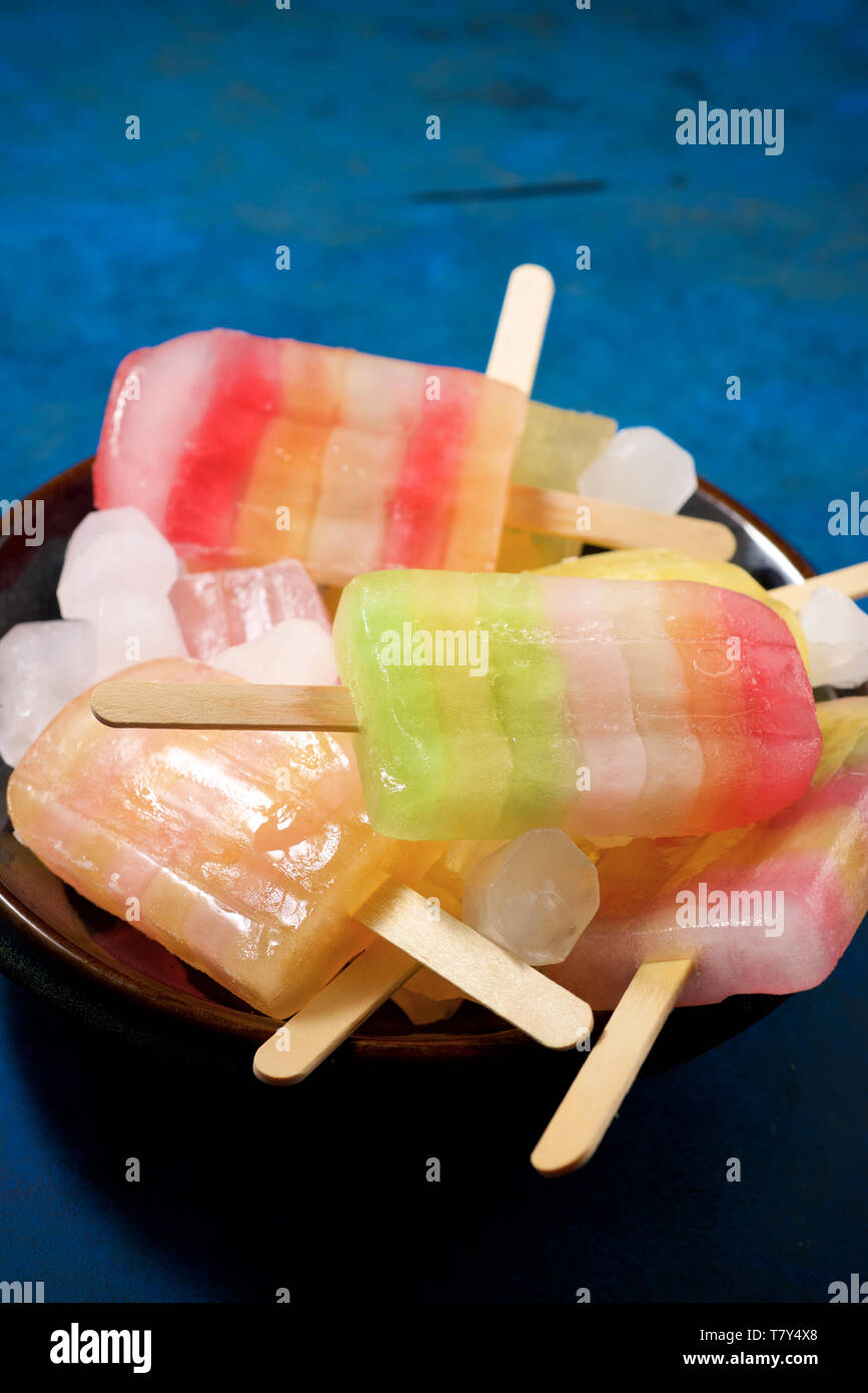 Popsicles on a blue table Stock Photo - Alamy