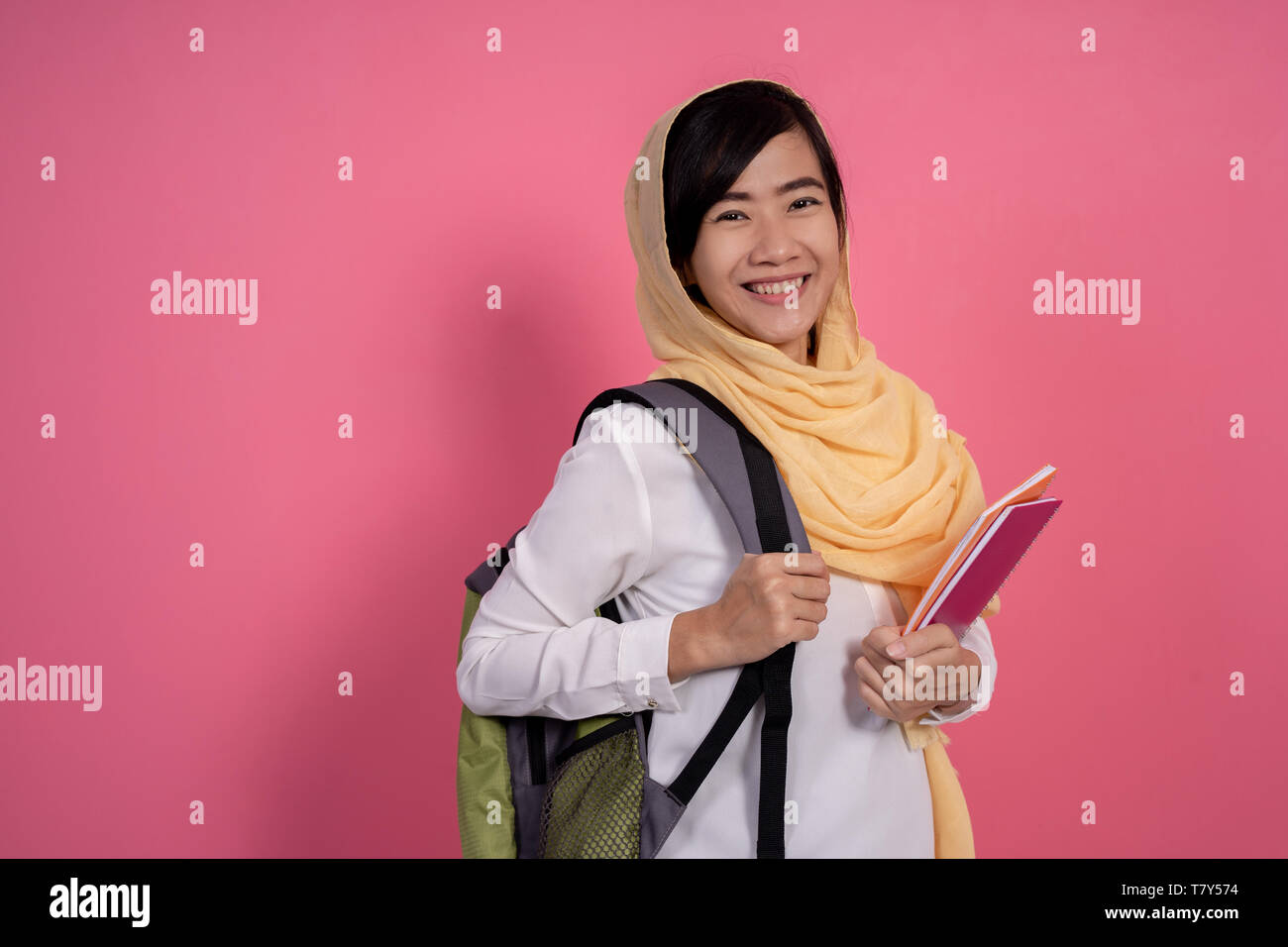 happy young muslim student smiling over pink background Stock Photo - Alamy