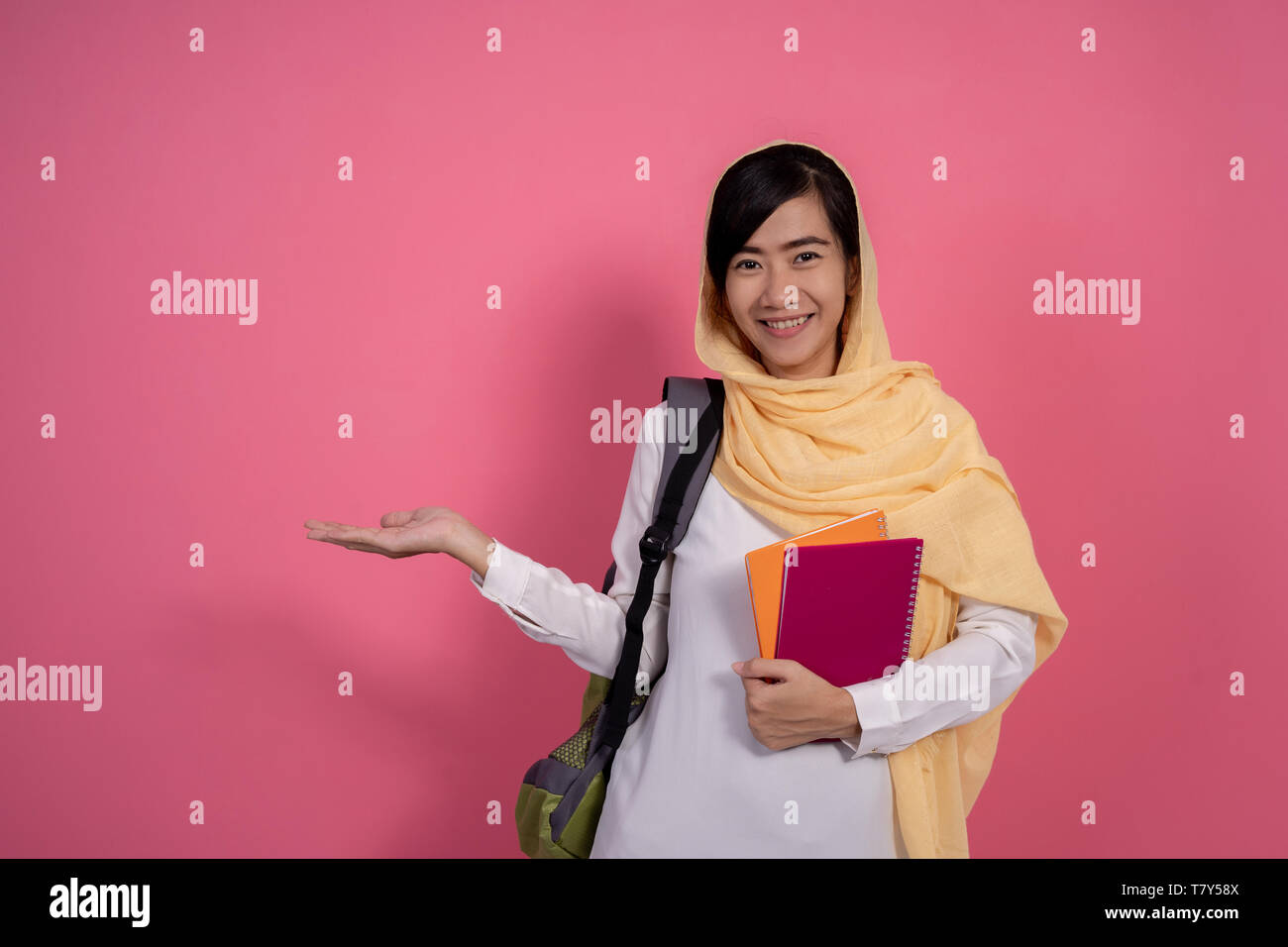 happy young muslim student smiling over pink background Stock Photo - Alamy