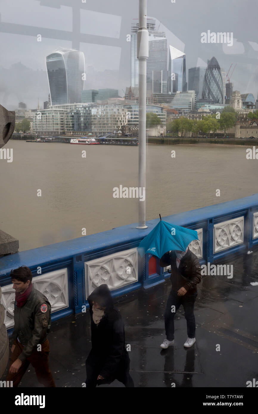 Tourists brave a wet and windy Tower Bridge, on Tower Bridge, on 8th ...