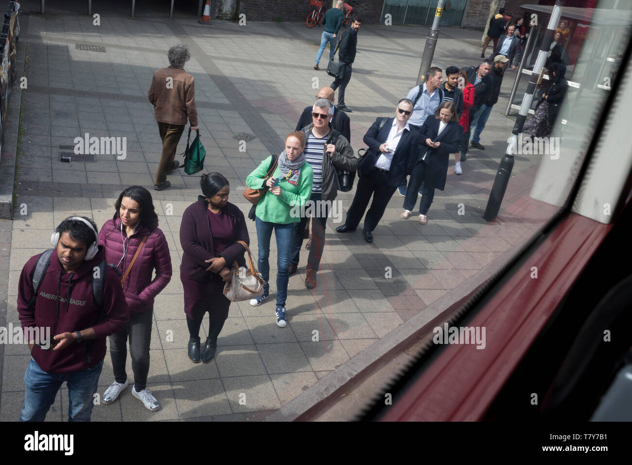 Bus passengers queue for their next service near Waterloo station, on ...