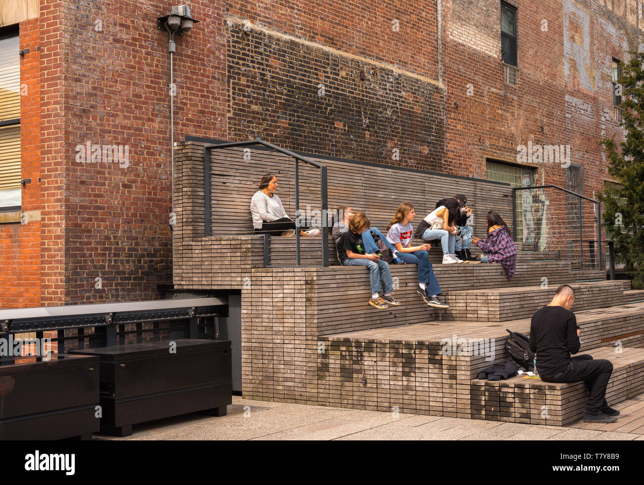 New York , NY USA -- April 12, 2017 -- Visitors to the HIgh Line sit ...