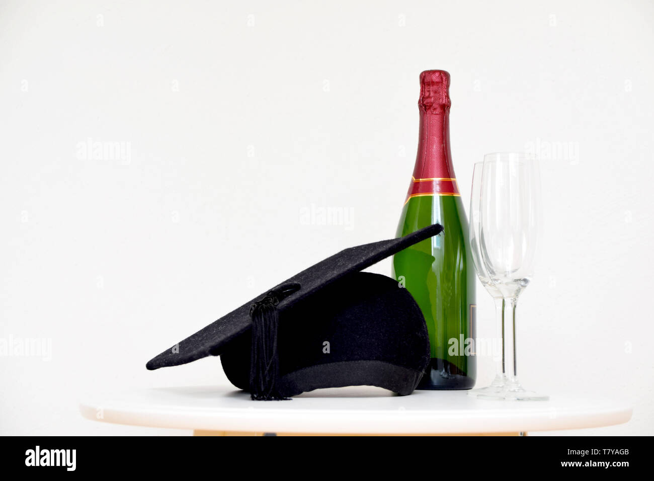 Graduation celebrations with graduation cap, champagne bottle and ...