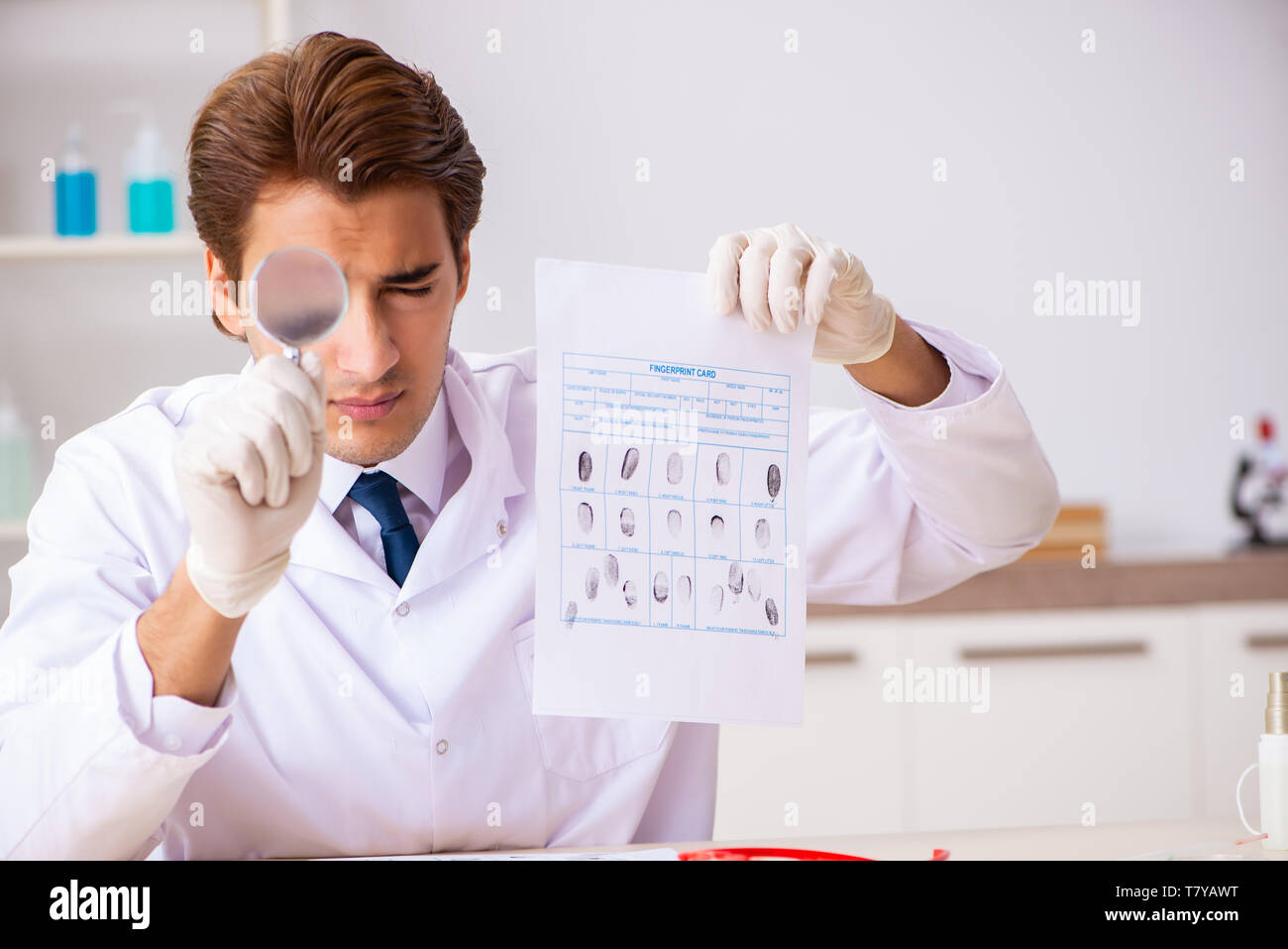Forensic expert studying fingerprints in the lab Stock Photo - Alamy