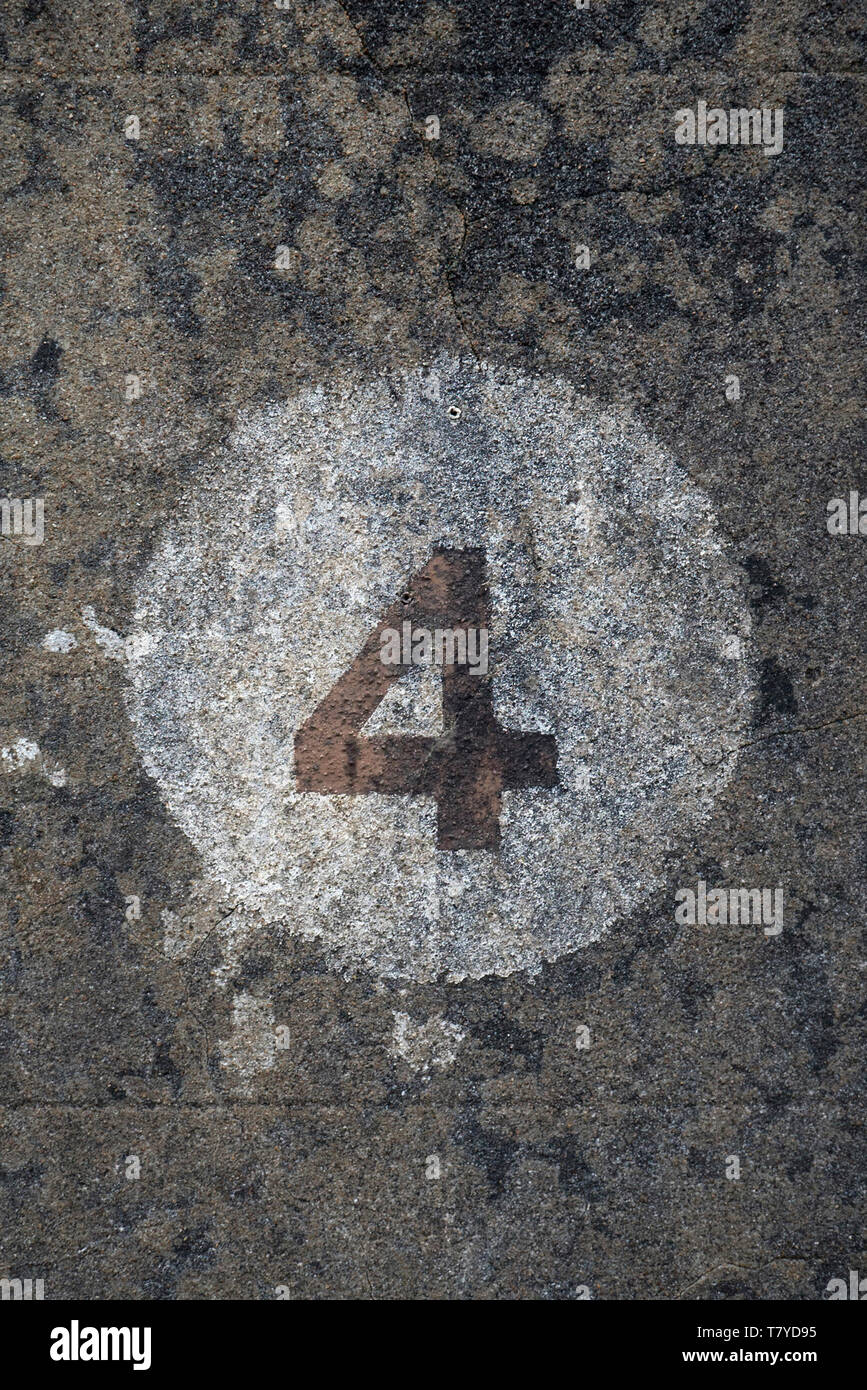 Number Four Door Number Within A White Painted Circle On A Stone Wall ...