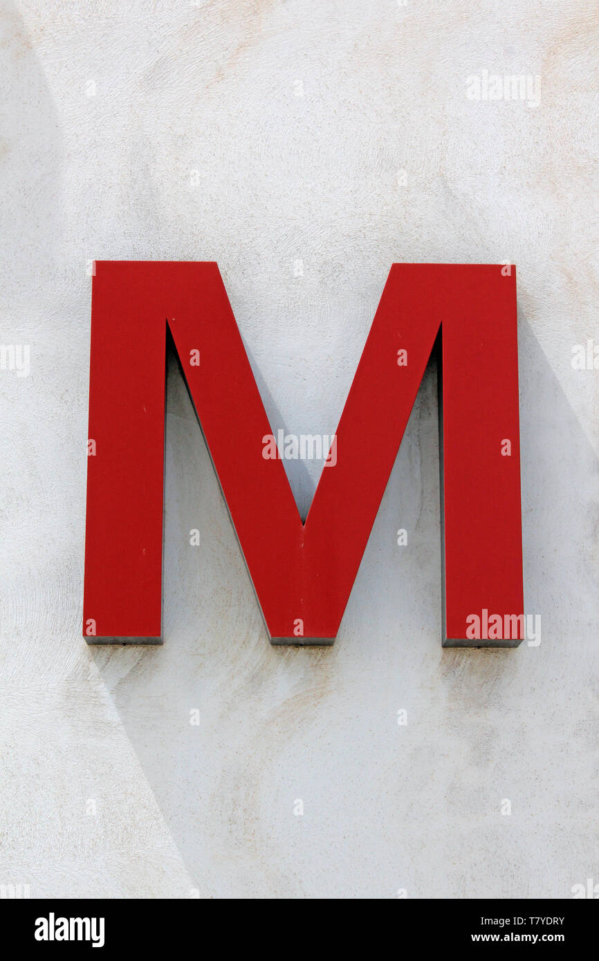 Red metal letter M high relief on a wall Stock Photo - Alamy