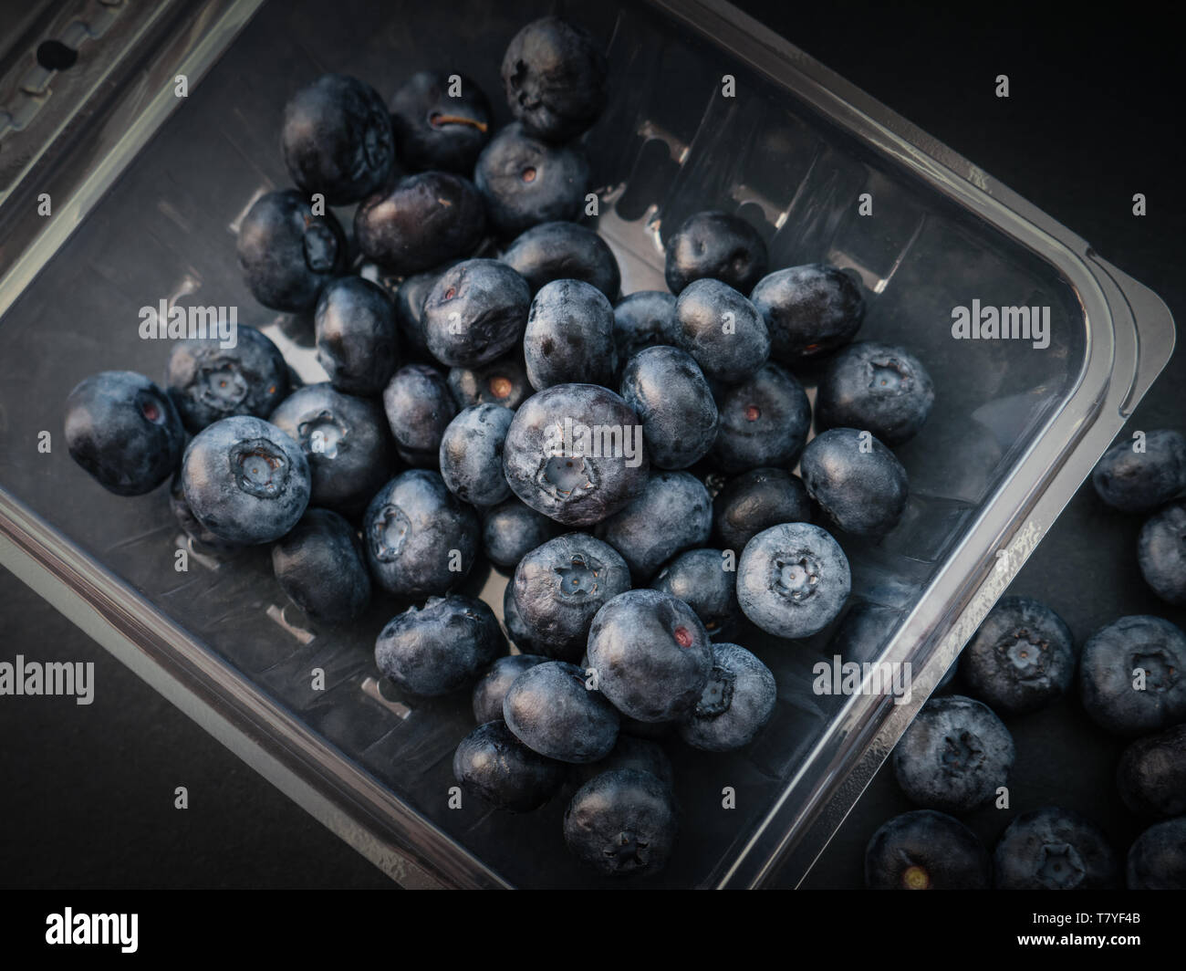 Natural looking blueberries on dark background. Top view. Selective ...