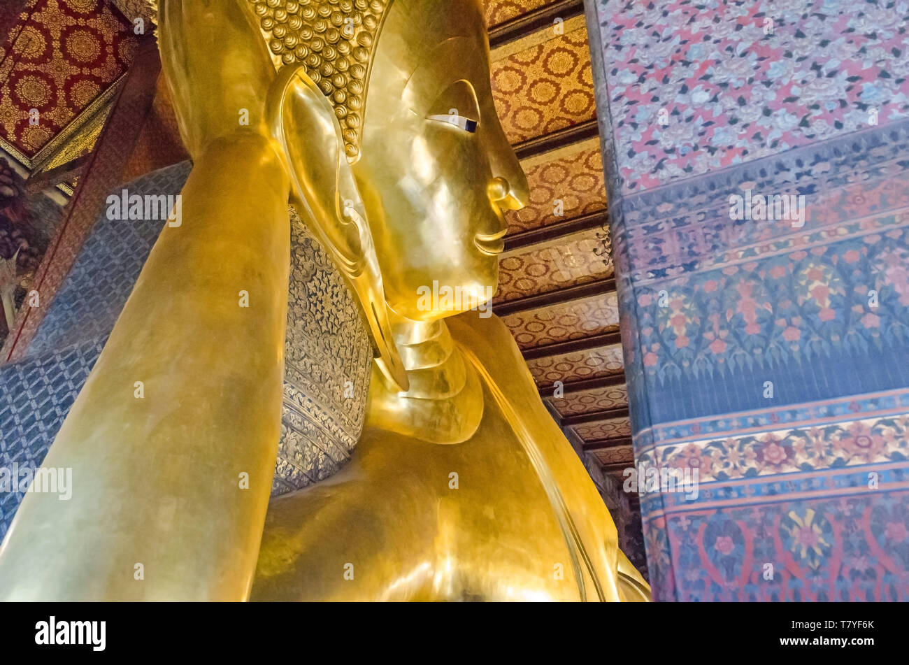 Right arm supporting the head with tight curls of the Reclining Buddha ...