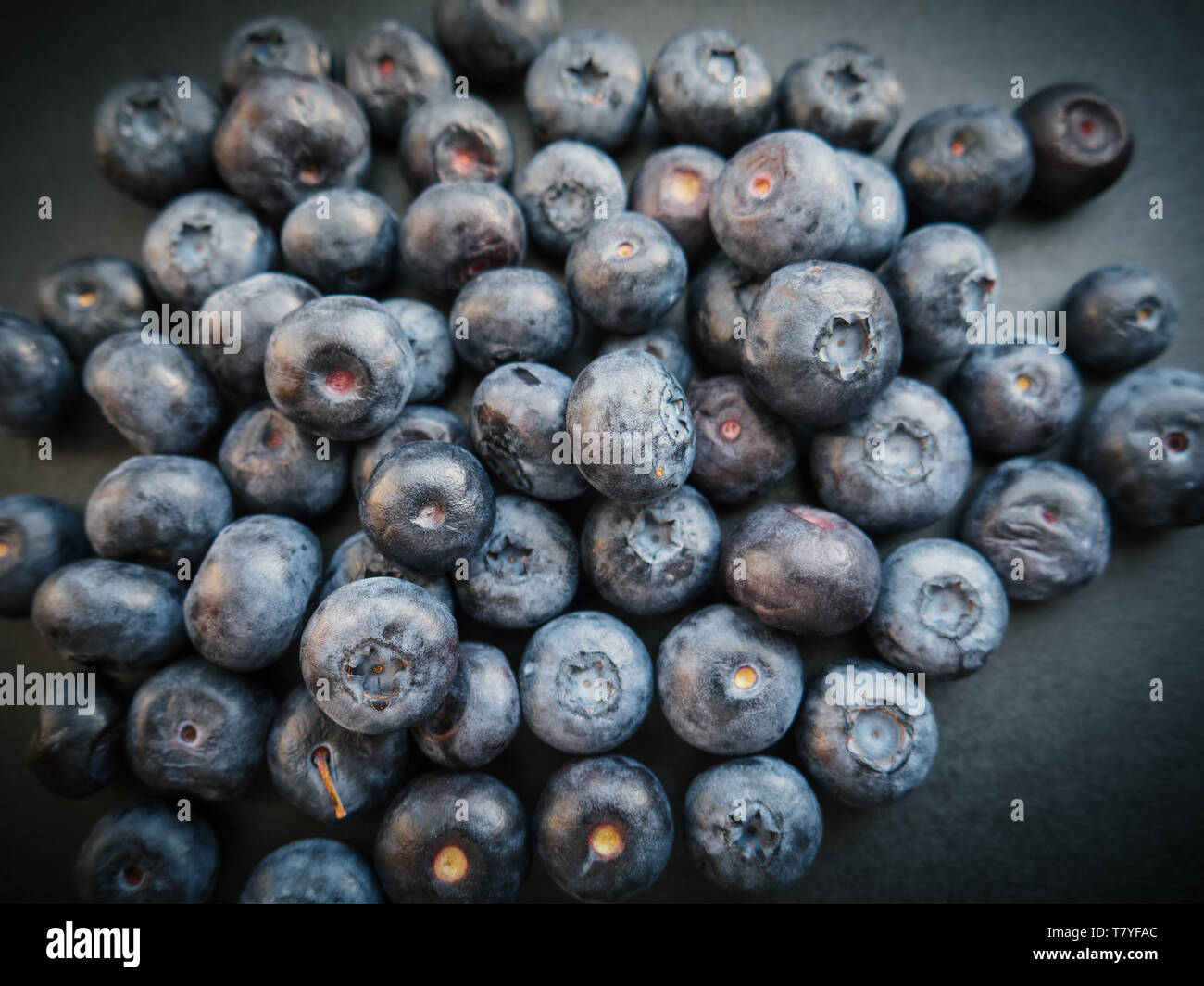 Natural looking blueberries on dark background. Top view. Selective ...