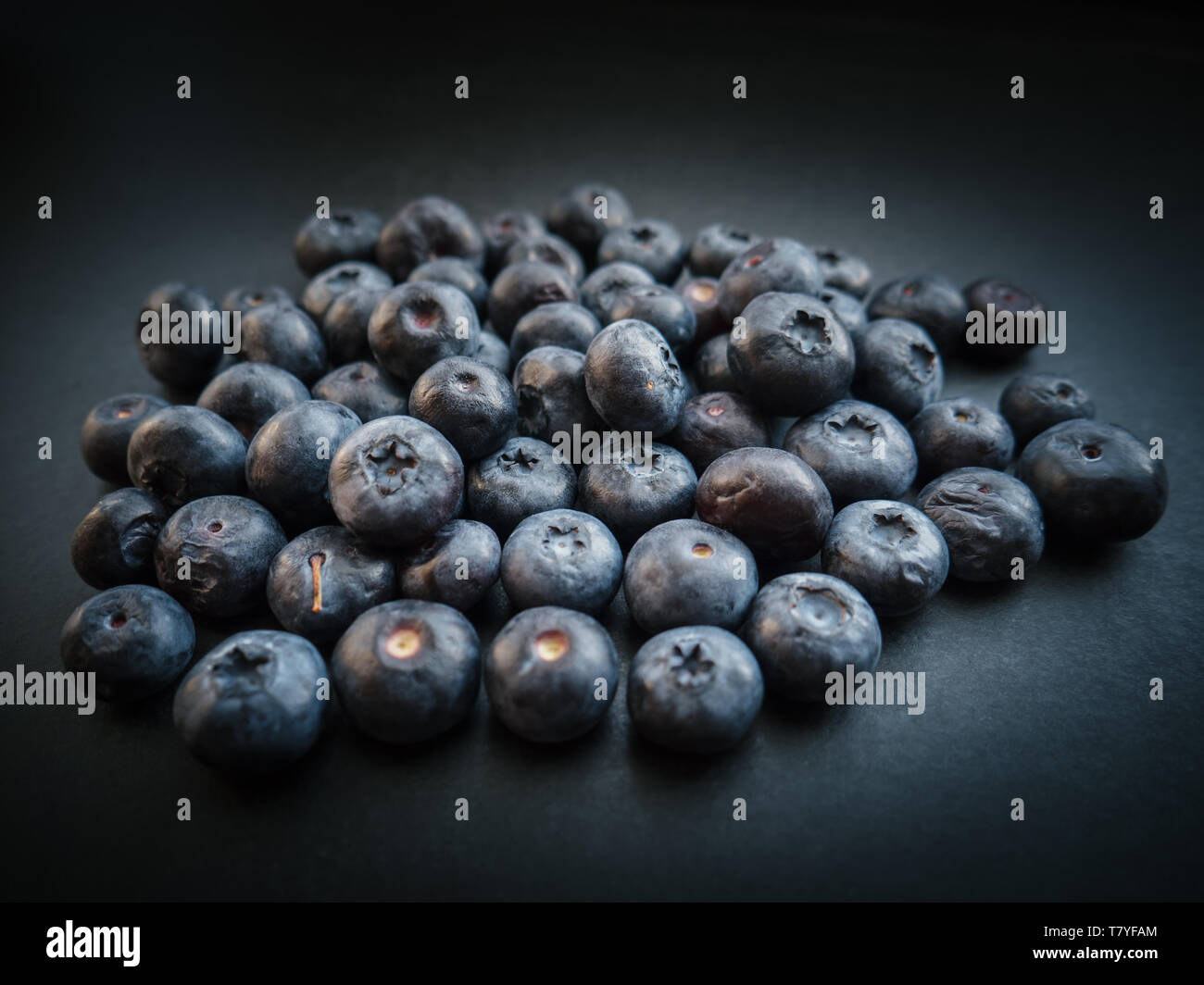 Natural looking blueberries on dark background. Top view. Selective ...