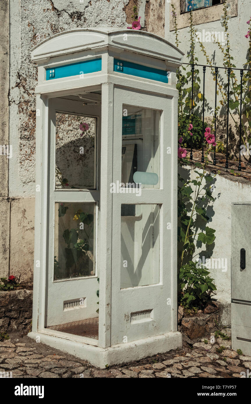 Charming painted wood telephone booth at a cobblestone alley, in a ...