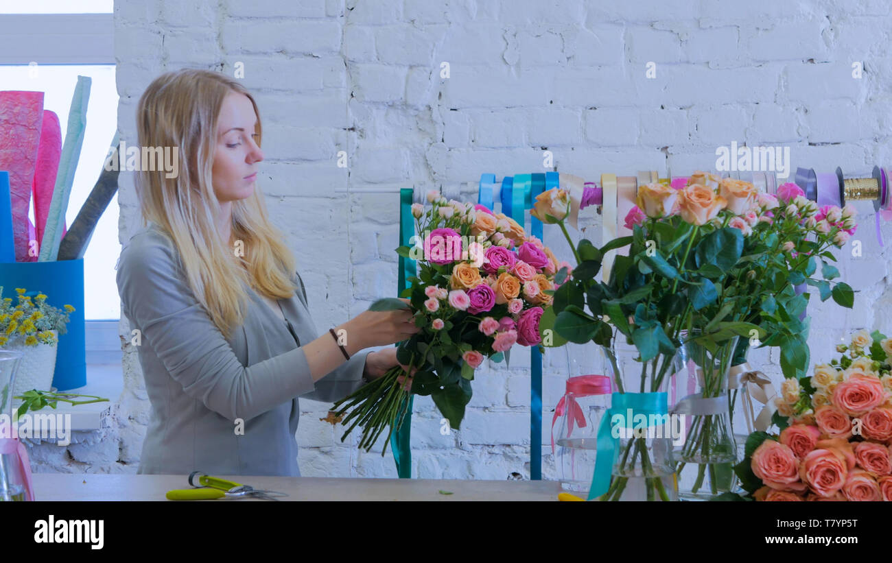 Professional florist making beautiful bouquet at flower store Stock ...