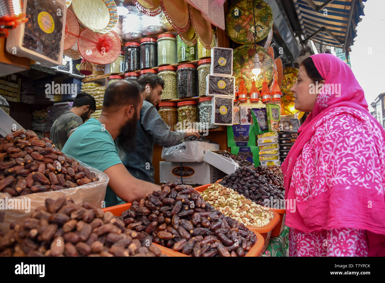 A Kashmiri vendor seen packing dates for his customers at a shop in ...