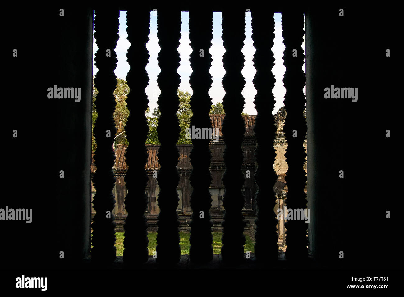 View of outer wall through window with colonettes (columns) at Angkor ...