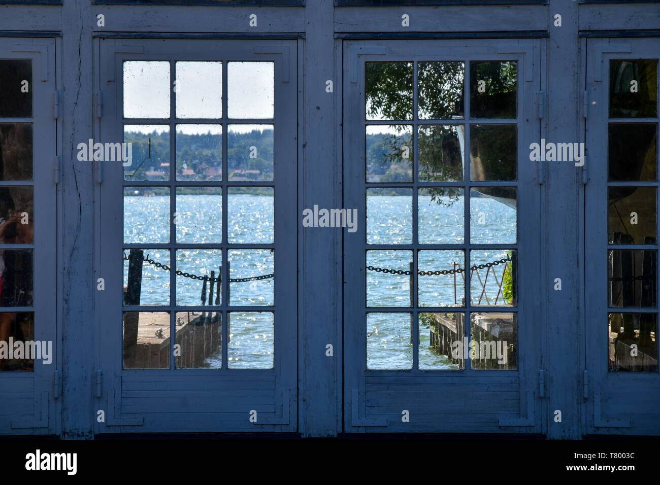 Lake seen through windows at dock Stock Photo - Alamy