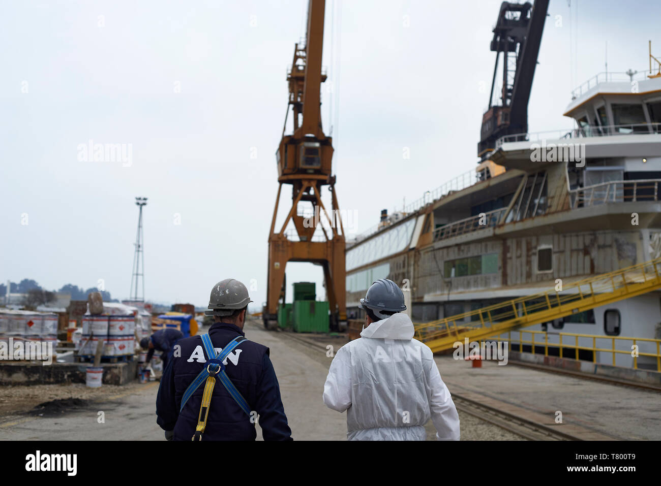 Labour shipping construction workers at the yard working on a new ship ...